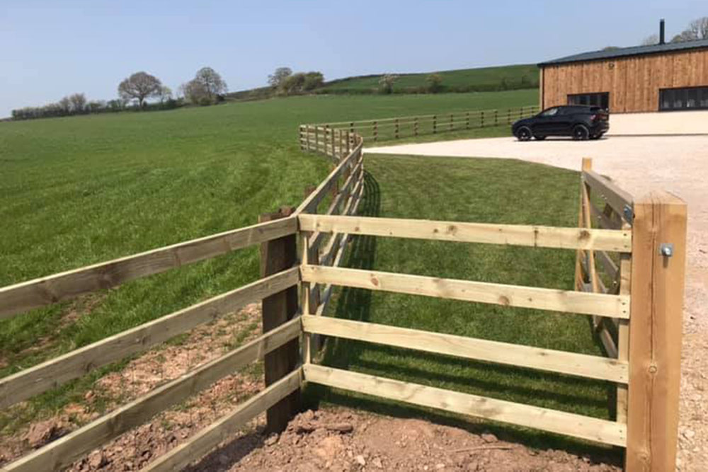 HC4 posts and motorway rails around a barn | MJB Fencing Limited