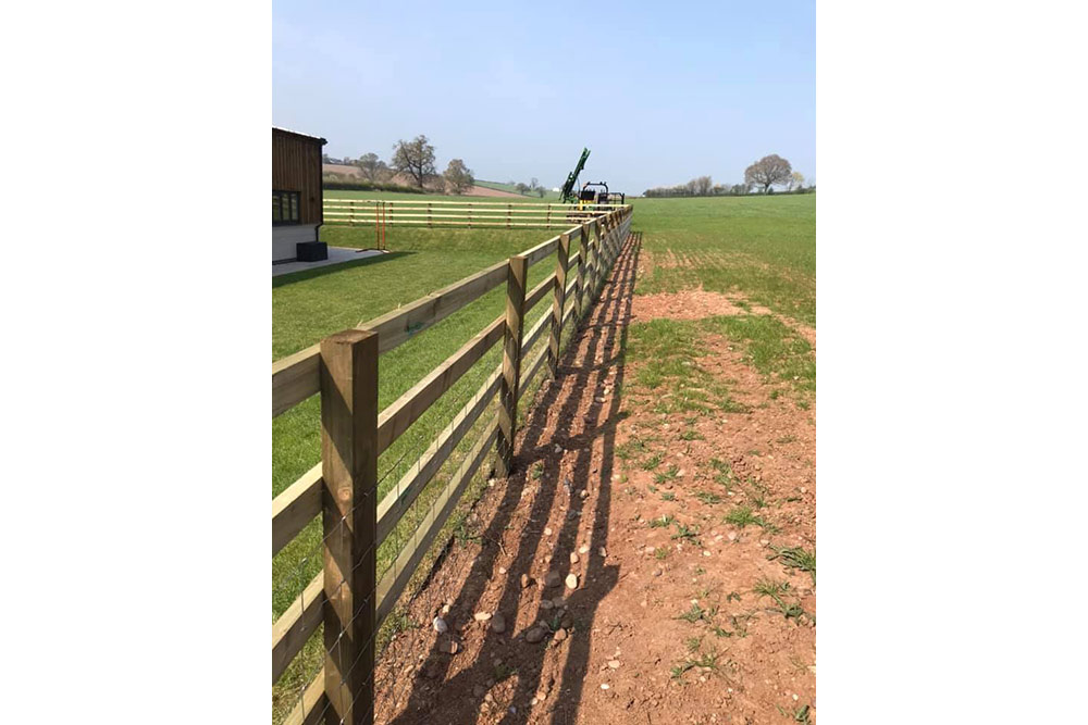 HC4 posts and motorway rails around a barn | MJB Fencing Limited