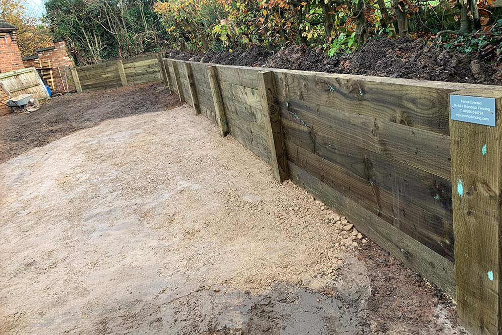 Retaining sleeper wall | MJB Fencing Limited